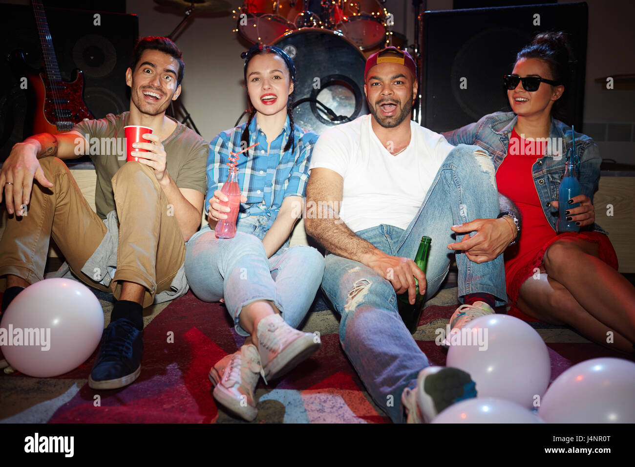 Multi-ethnic group of smiling contemporary people hanging out in ...