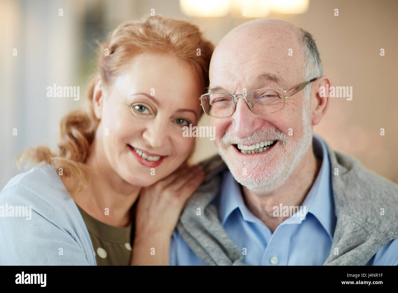 Affectionate husband and wife looking at camera Stock Photo - Alamy