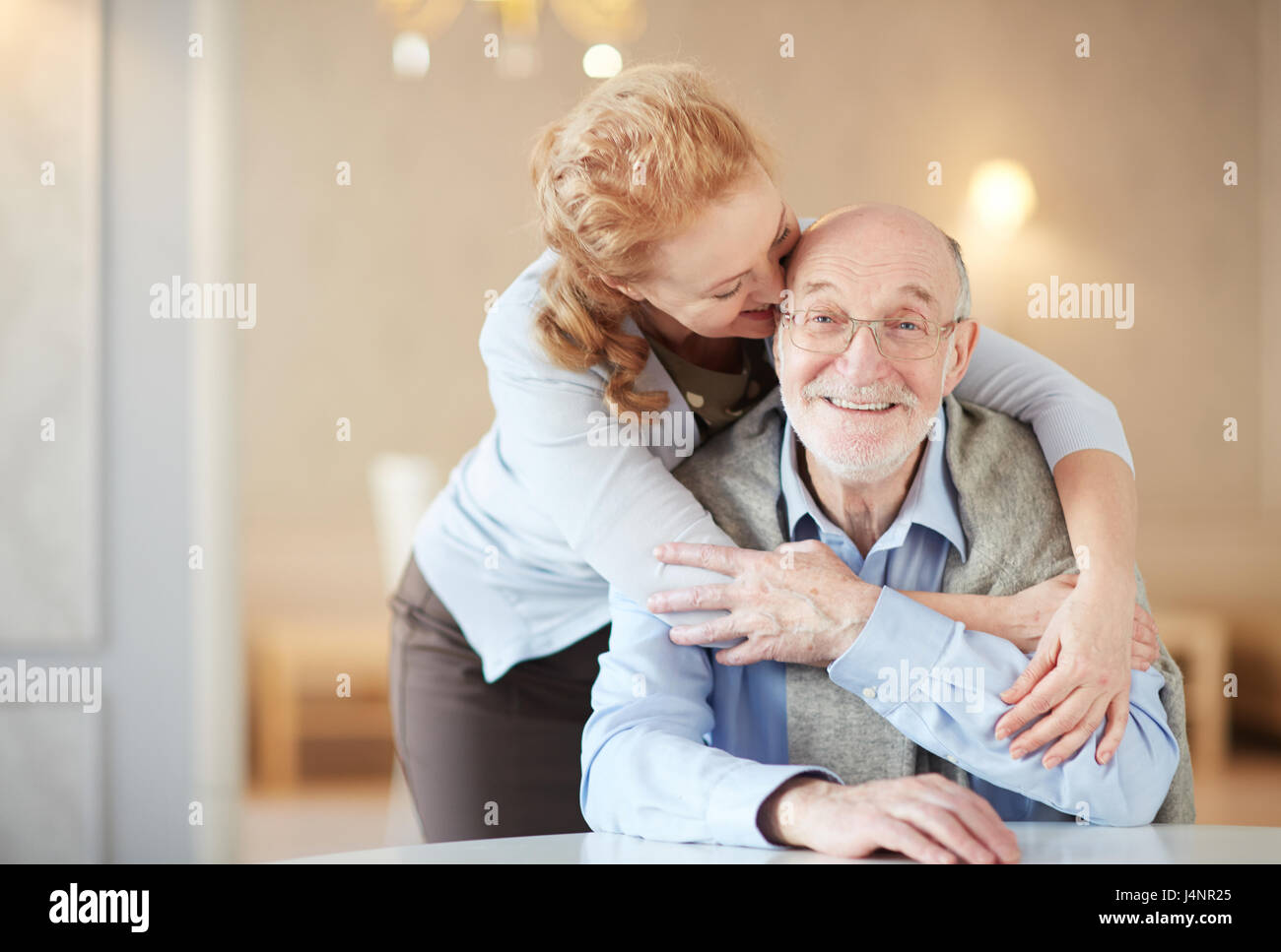 Amorous woman embracing and kissing her husband Stock Photo - Alamy