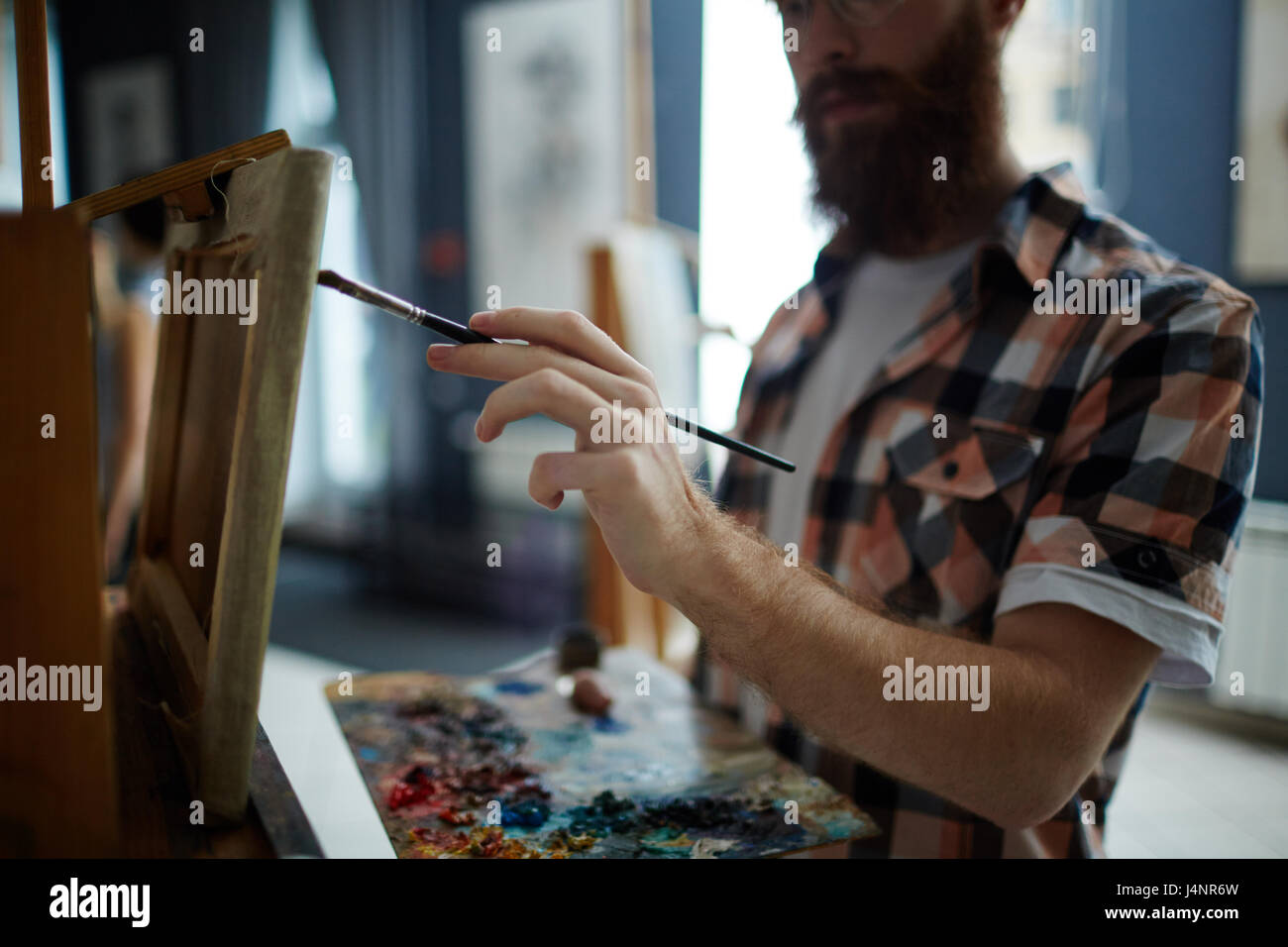 Artists hand holding paintbrush painting hi-res stock photography and ...