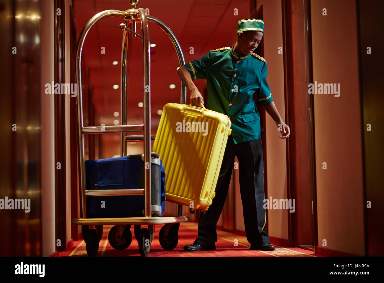 Bellhop carrying luggage in hotel hi-res stock photography and images ...