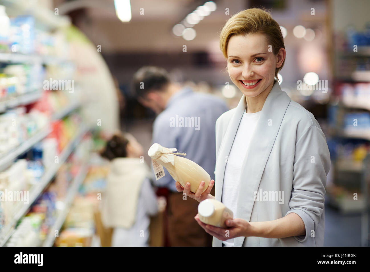 Woman buying milk in hi-res stock photography and images - Alamy