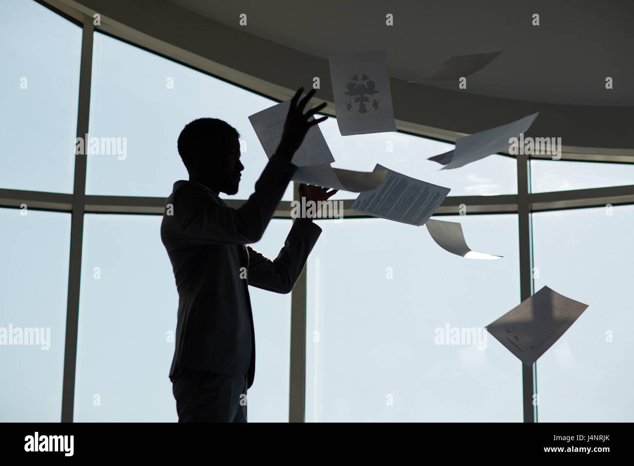 Ecstatic or irritated businessman throwing papers upwards Stock Photo ...