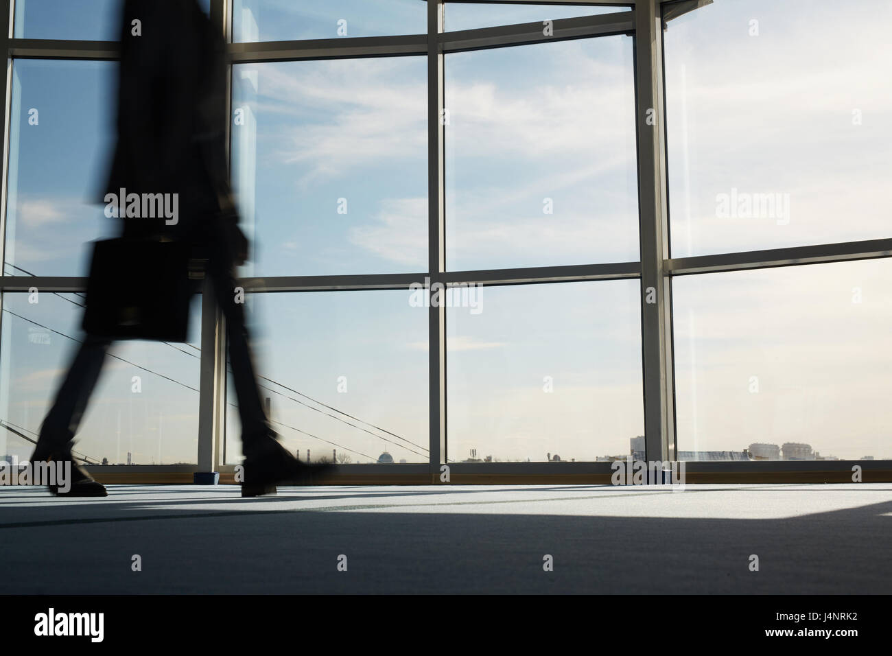 Human with briefcase moving inside office center Stock Photo - Alamy