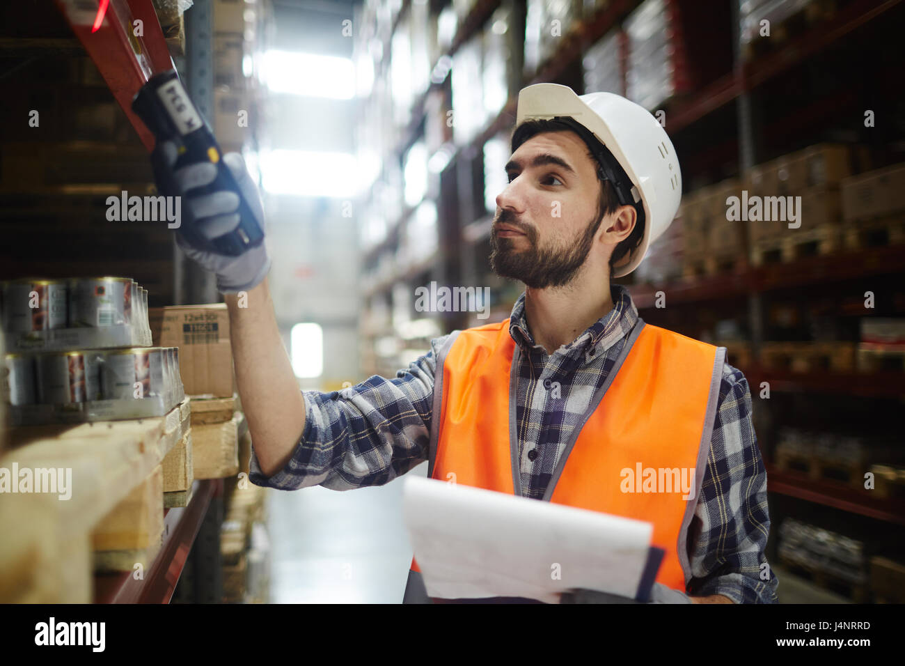 Dispatcher of warehouse scanning packed goods Stock Photo - Alamy