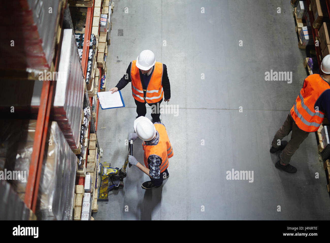 Chief worker giving instructions to loader of goods Stock Photo - Alamy
