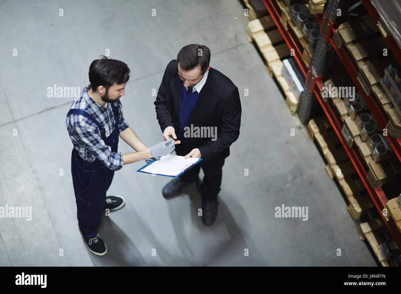 Dispatcher of warehouse signing document before receiving goods Stock ...