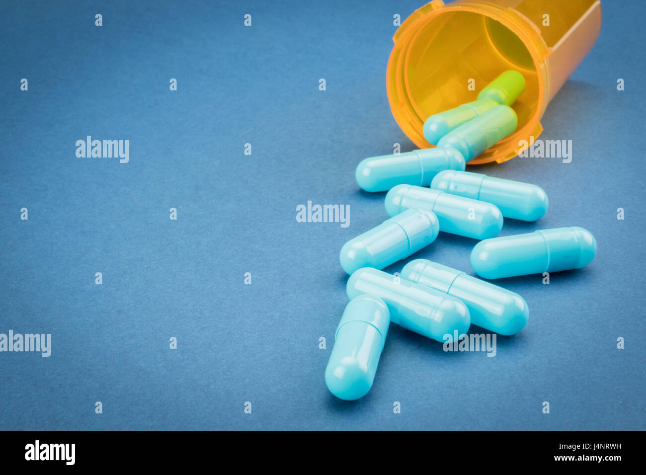 Blue capsules going out of color container transparent amber Stock ...