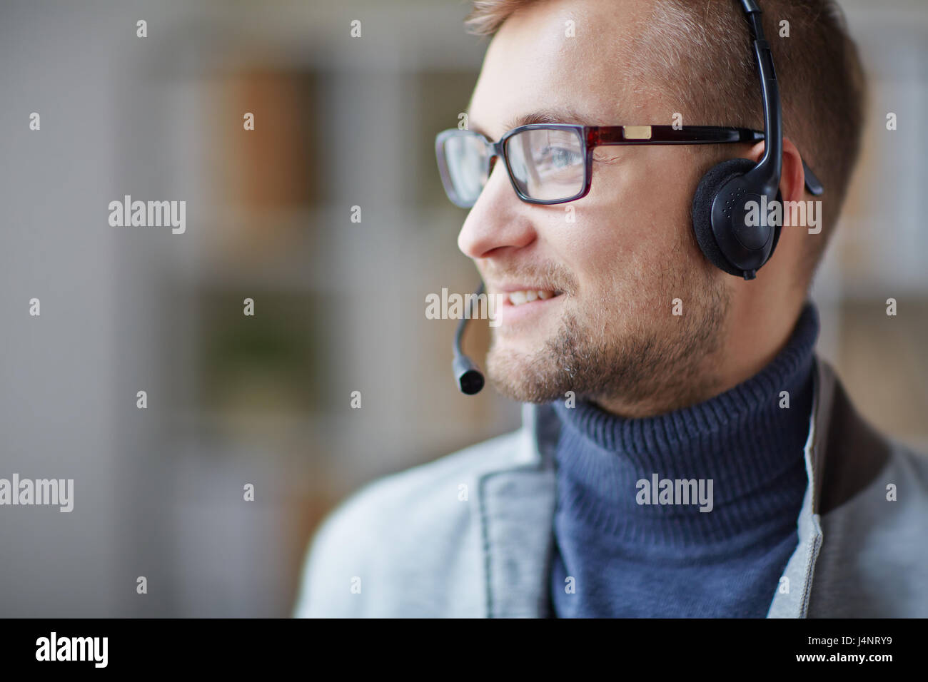 Young operator speaking in microphone to client Stock Photo - Alamy