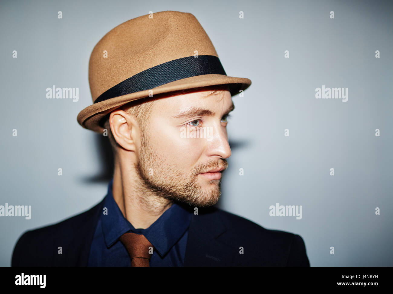 Attractive young man in hat and suit Stock Photo - Alamy