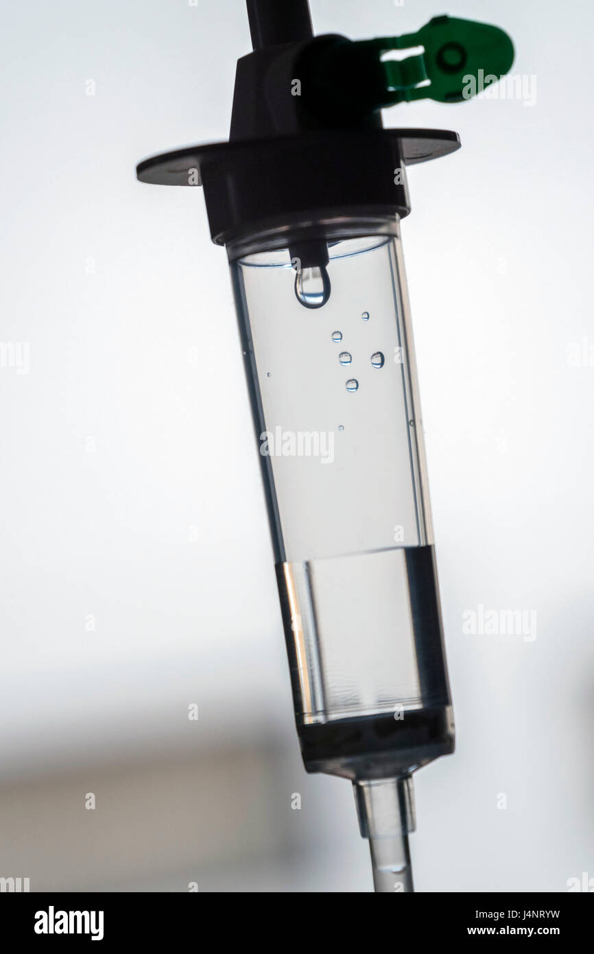 Dropper supplying serum to a patient in hospital on white background ...