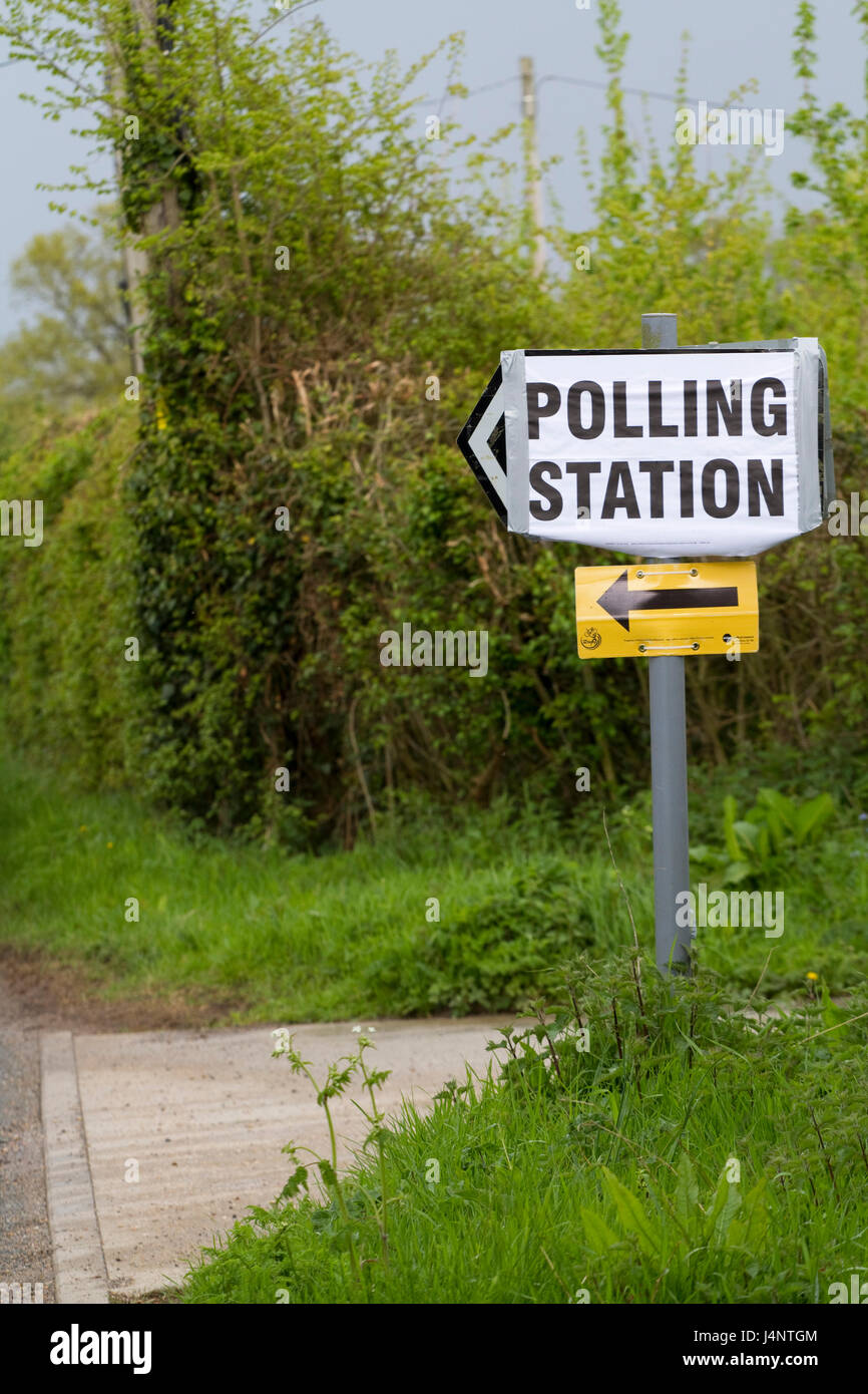 Polling station sign on a road direction arrow Stock Photo - Alamy