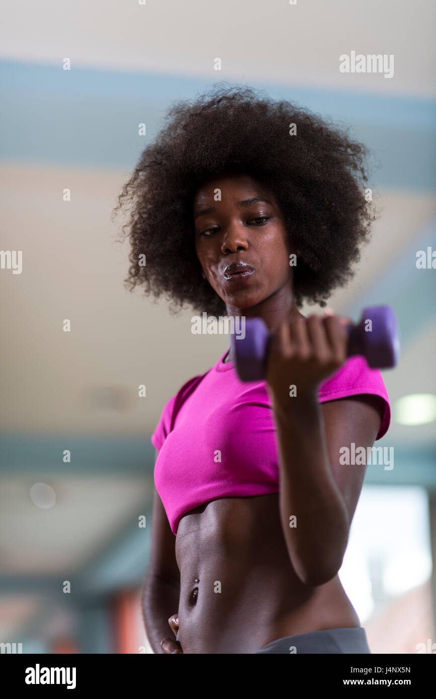 happy healthy african american woman working out in a crossfit gym on ...