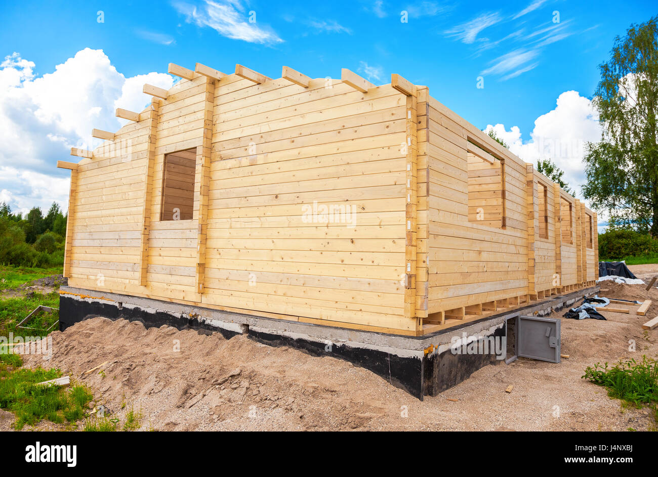 Construction of a new wooden house in summer sunny day Stock Photo - Alamy