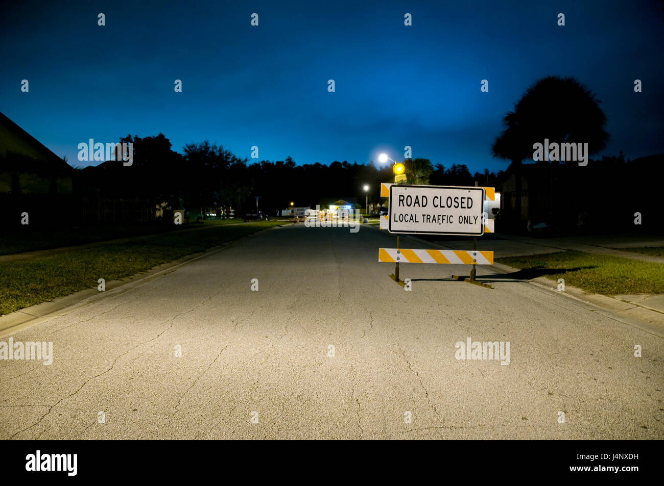 Road Closed signage due to construction ahead at night Stock Photo - Alamy