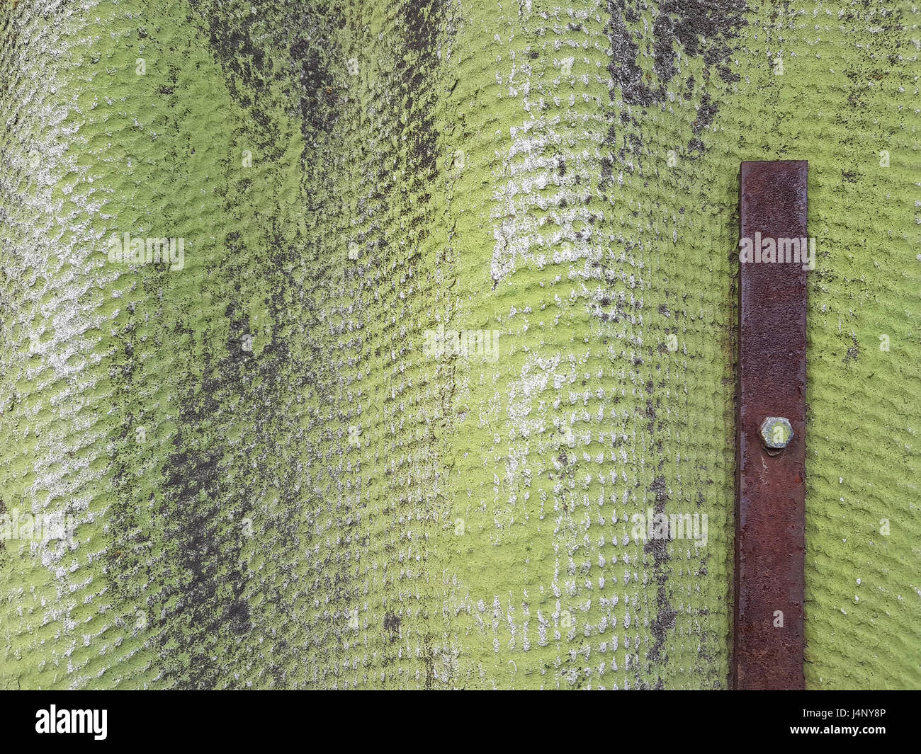 Piece of old abandoned slate gray color, curved waves, covered with ...