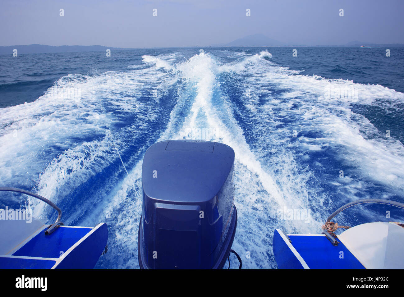 rear view of speed boat running high speed on blue sea water use for ...