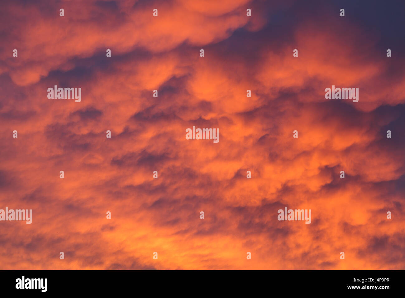 Fiery vivid sunset sky clouds Stock Photo - Alamy