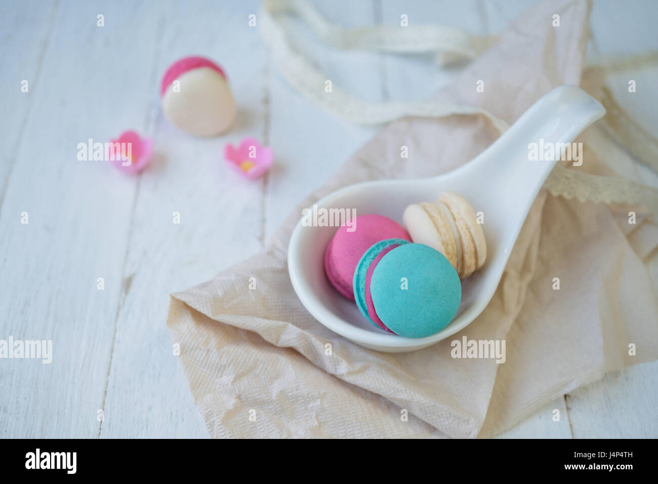 Colorful macaroon set on white wood background Stock Photo - Alamy