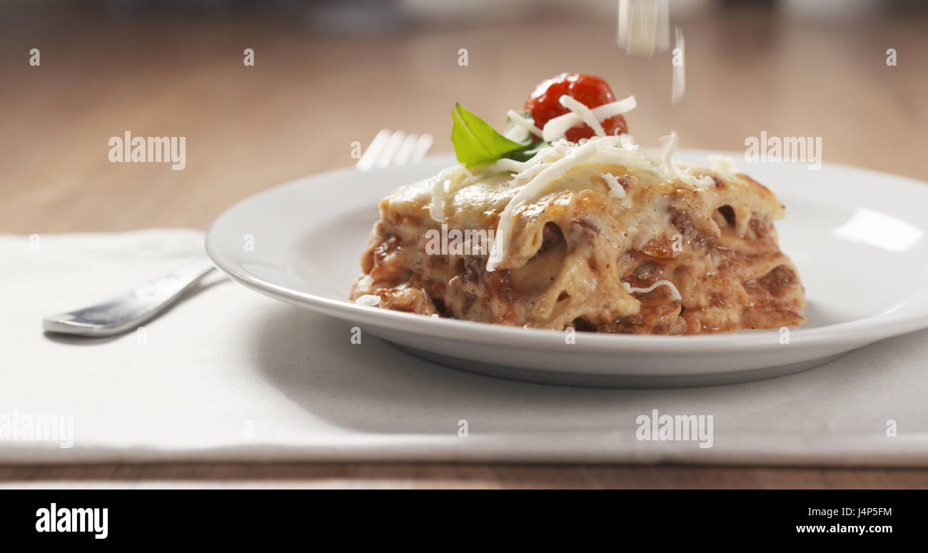 homemade lasagna portion on white plate on wood table Stock Photo - Alamy