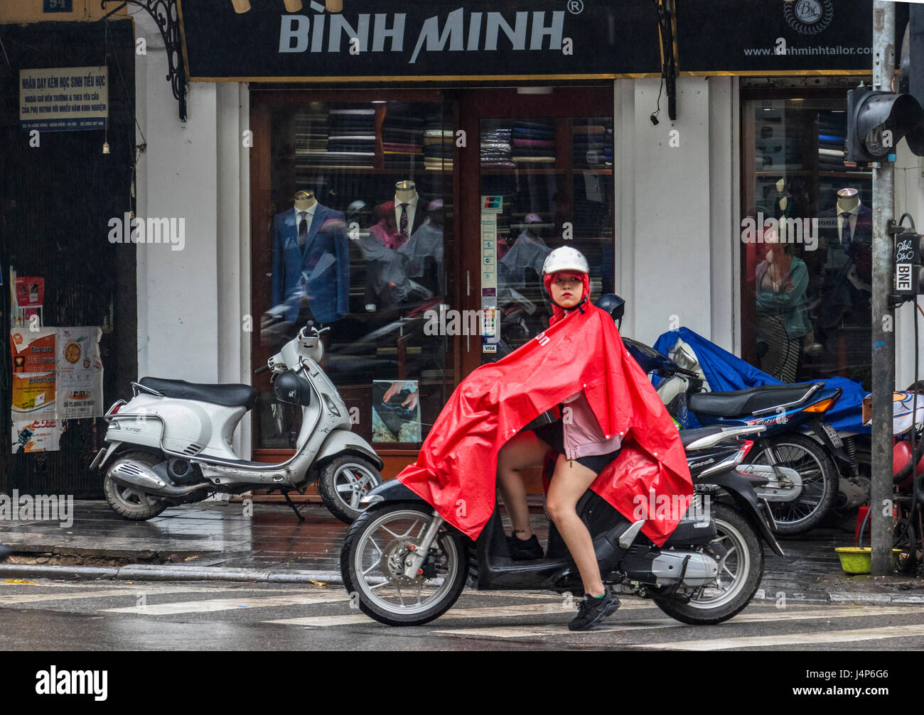 Motor cycle riders on a wet day in Hanoi Vietnam Stock Photo - Alamy