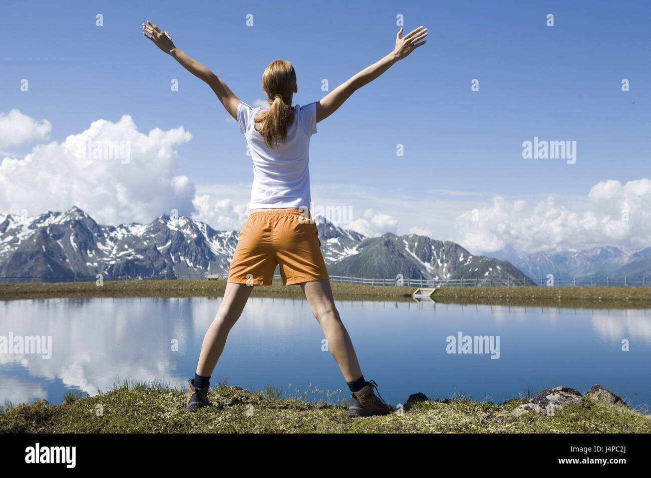 Woman, young, walk, gesture, straddle, stretch, lakeside, back view ...