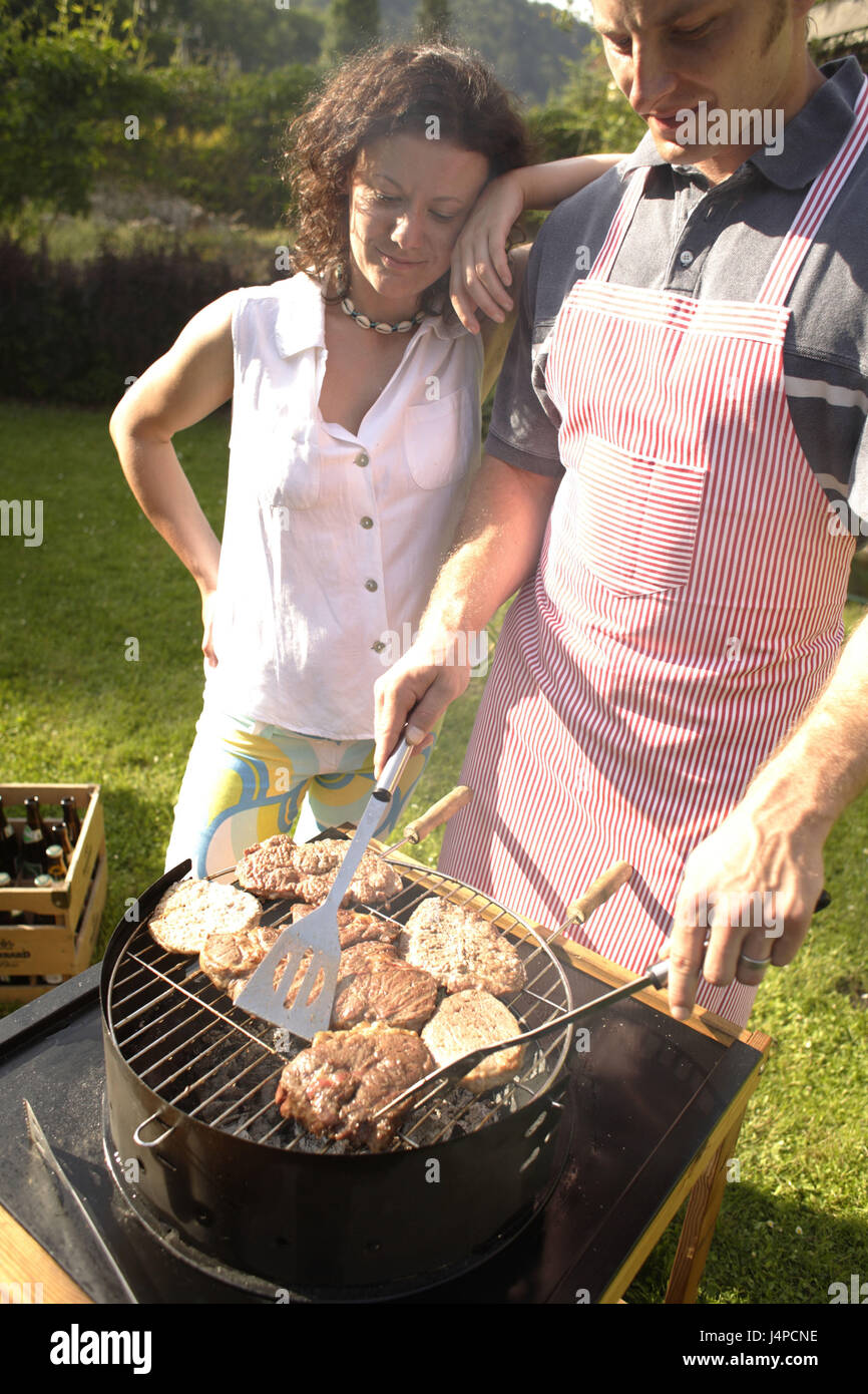 Garden party, couple, grill, meat, prepare, model released Stock Photo ...