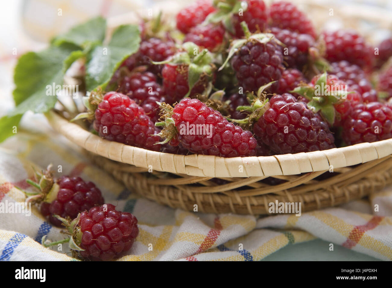 Raspberries in a basket Stock Photo - Alamy