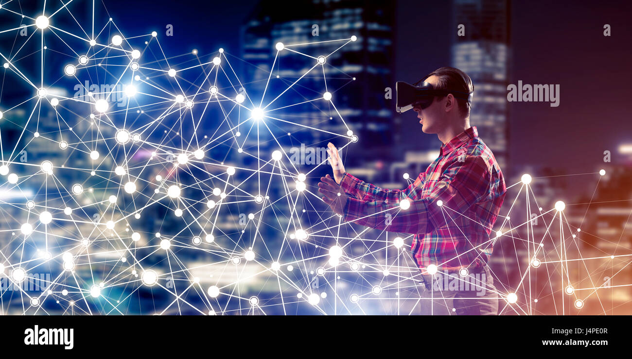 Guy wearing checked shirt and virtual mask reaching hand to feel Stock ...