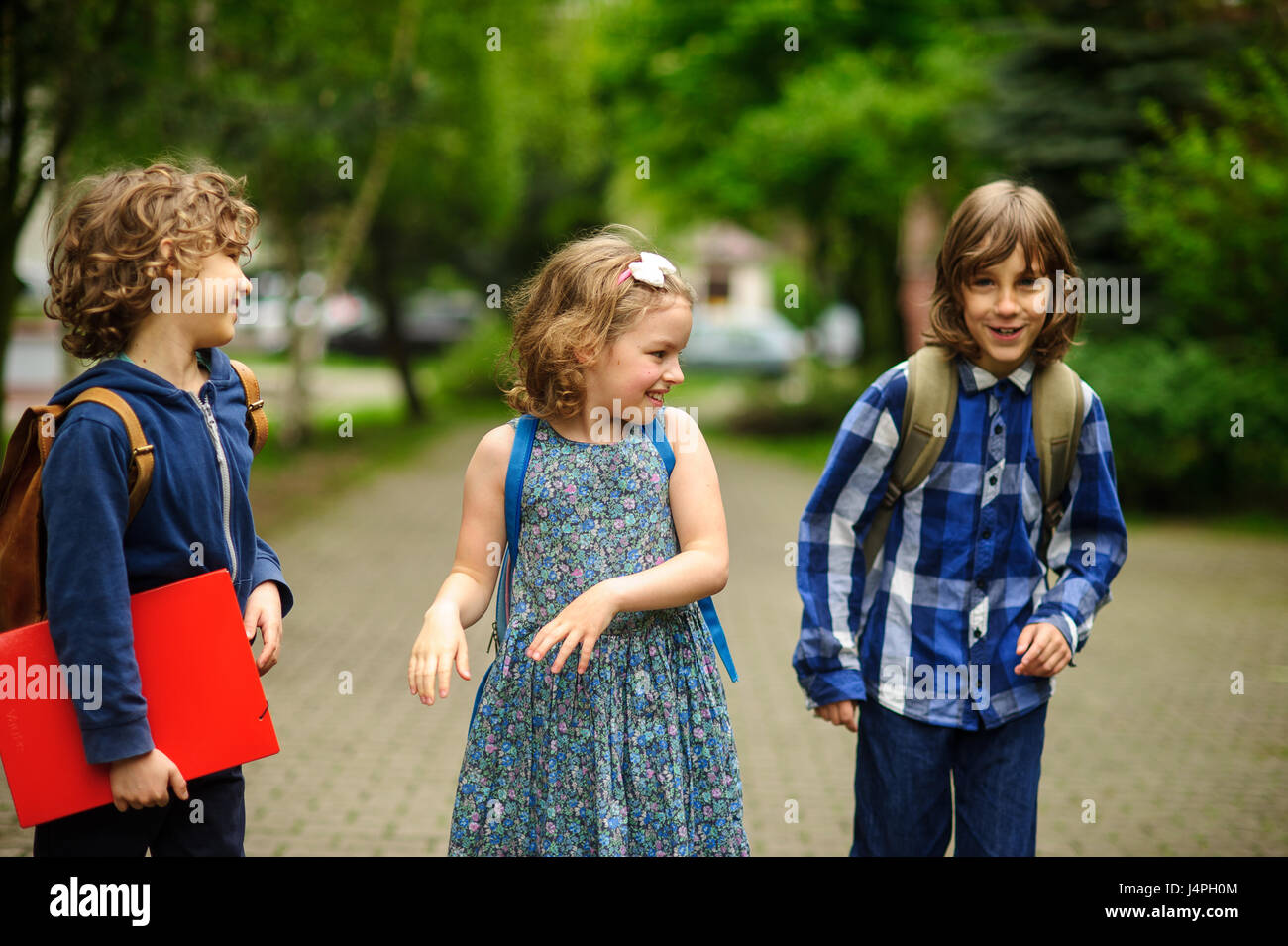 Little school students have started a game on the schoolyard. Two boys ...