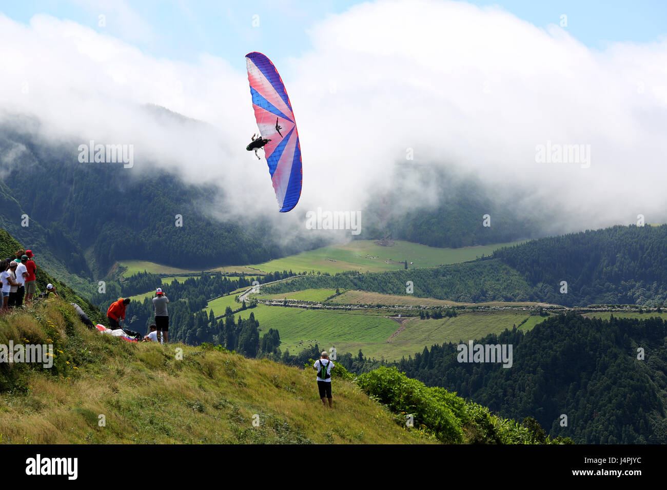 A paragliding acro pilot flying during the 22nd Azores Paragliding ...