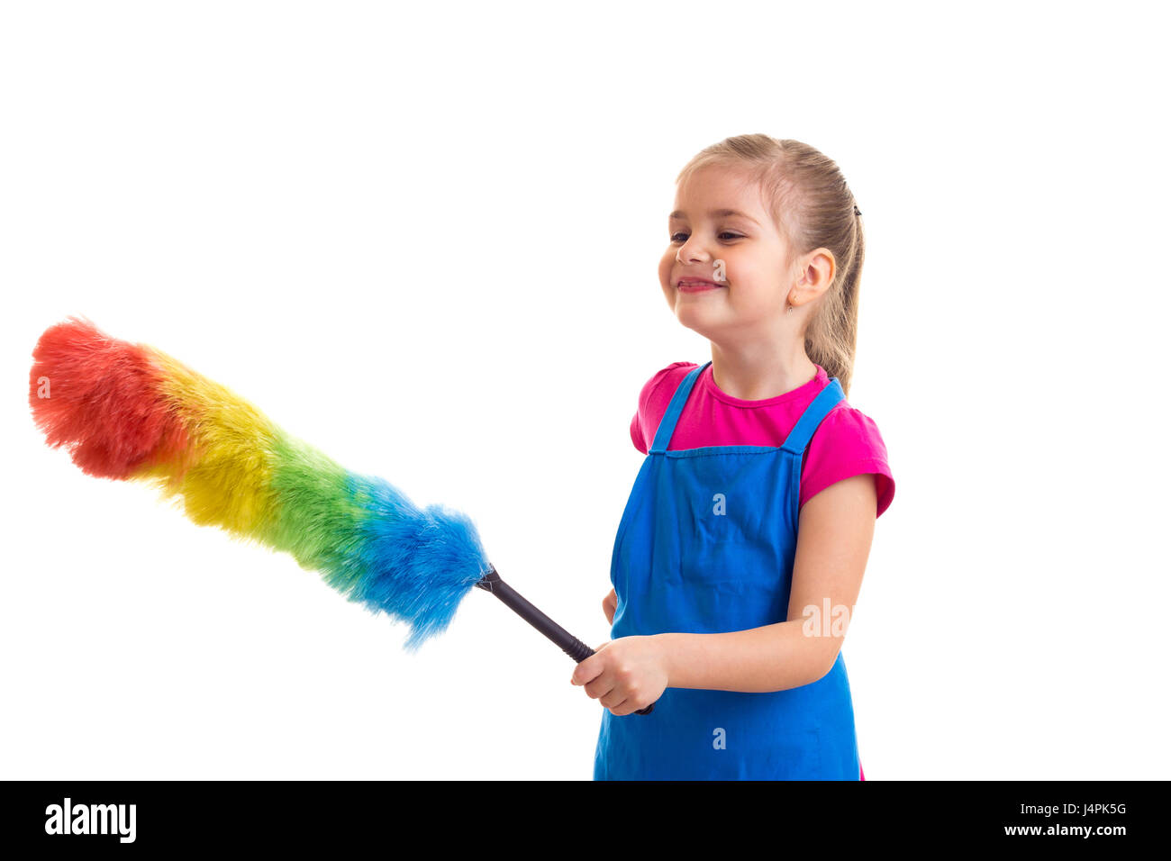 Girl in apron with duster Stock Photo - Alamy