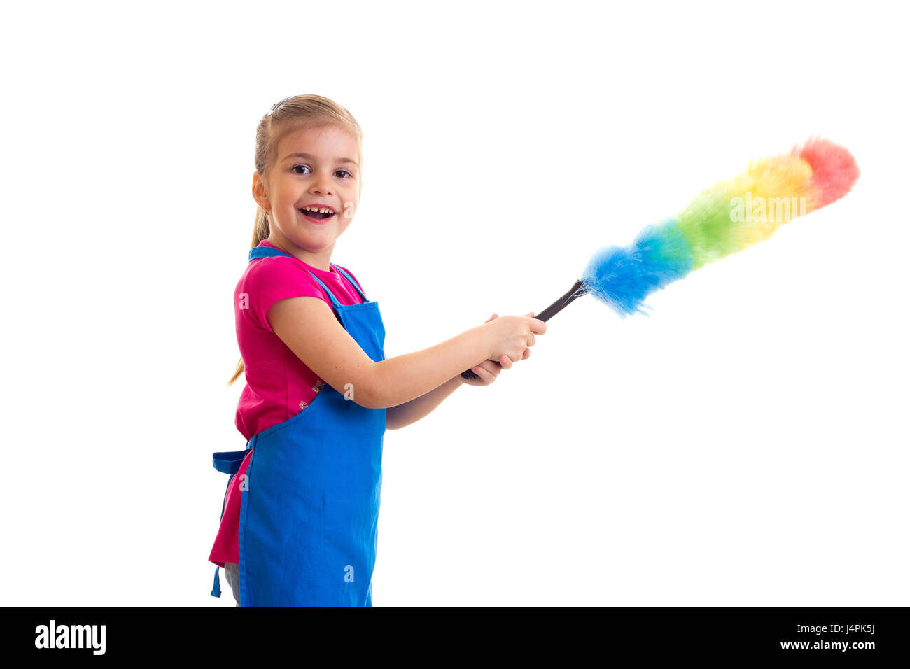 Girl in apron with duster Stock Photo - Alamy