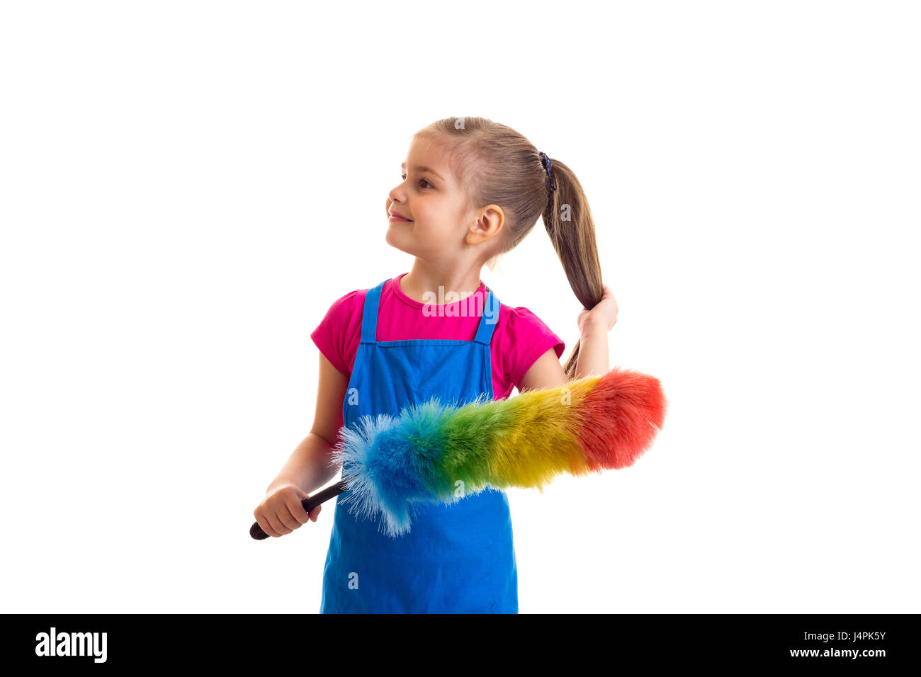 Girl in apron with duster Stock Photo - Alamy