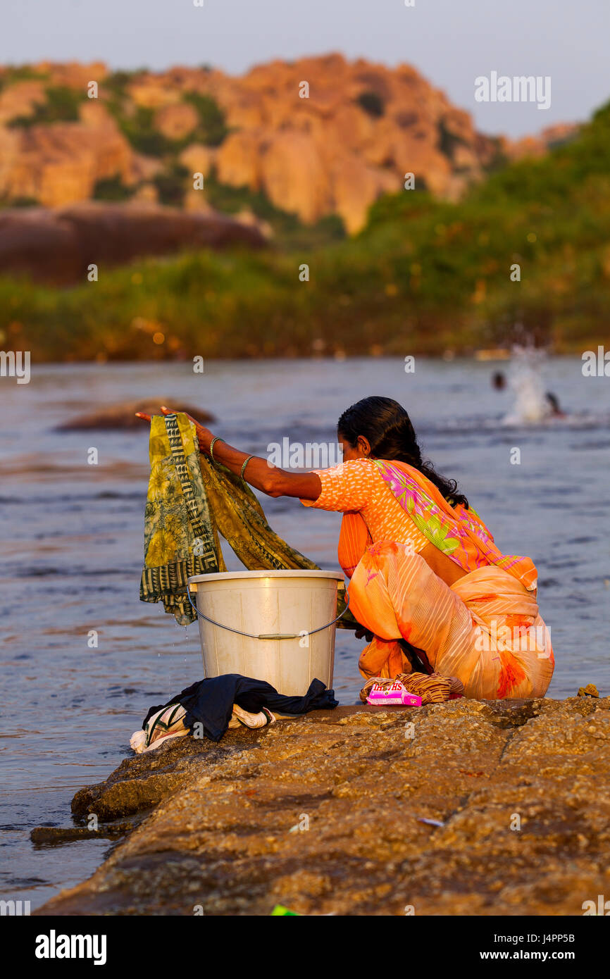 Indian woman washing clothes at Tungabhadra River, Hampi, Karnataka ...