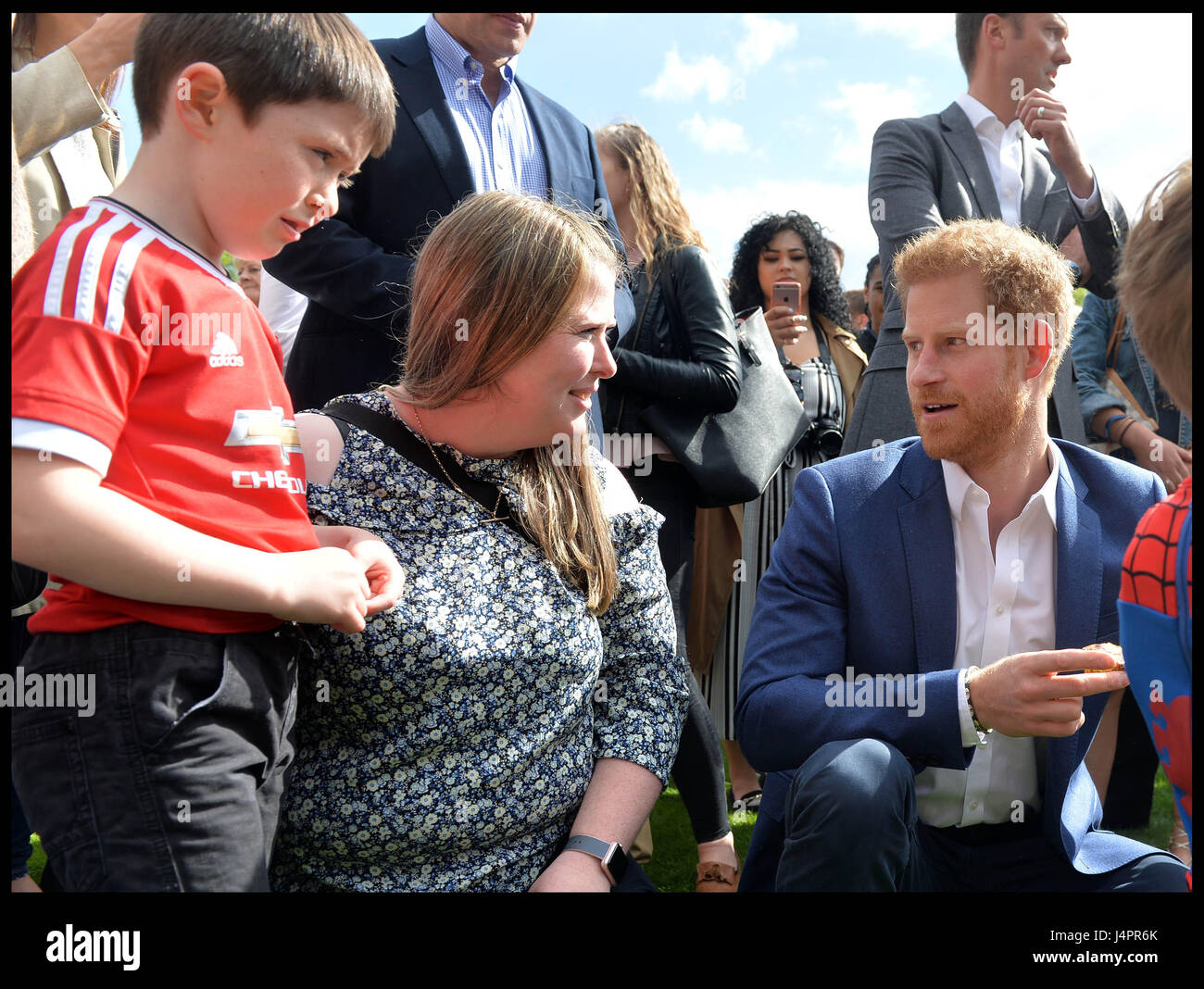 Prince Harry talks to Lee Rigby's wife Rebecca and his son Jack (left ...