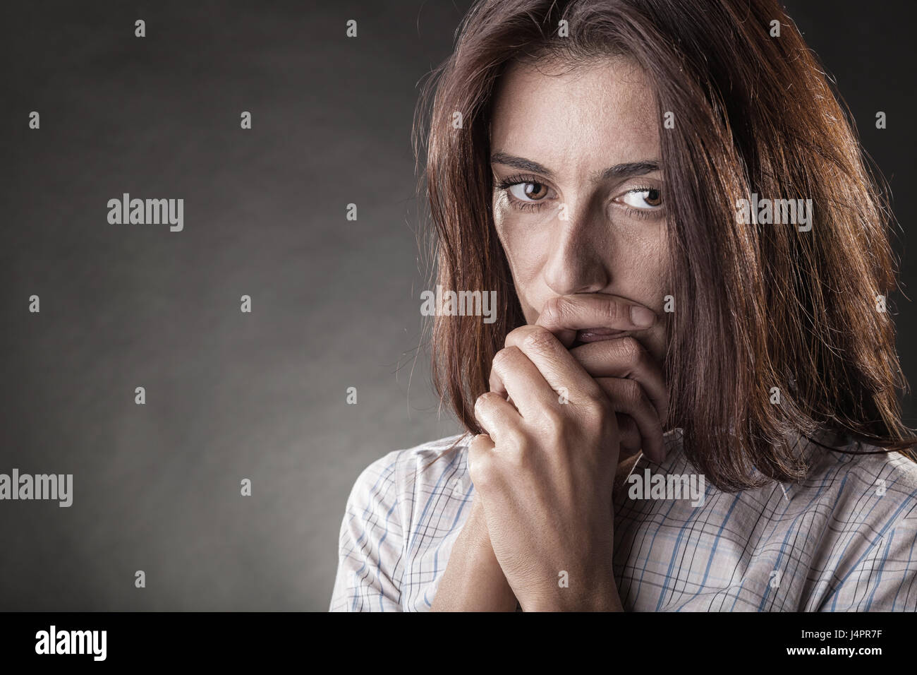 Young crying woman on a dark background Stock Photo - Alamy