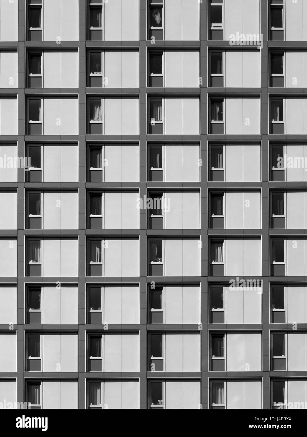 modern concrete housing development with repeating pattern windows ...