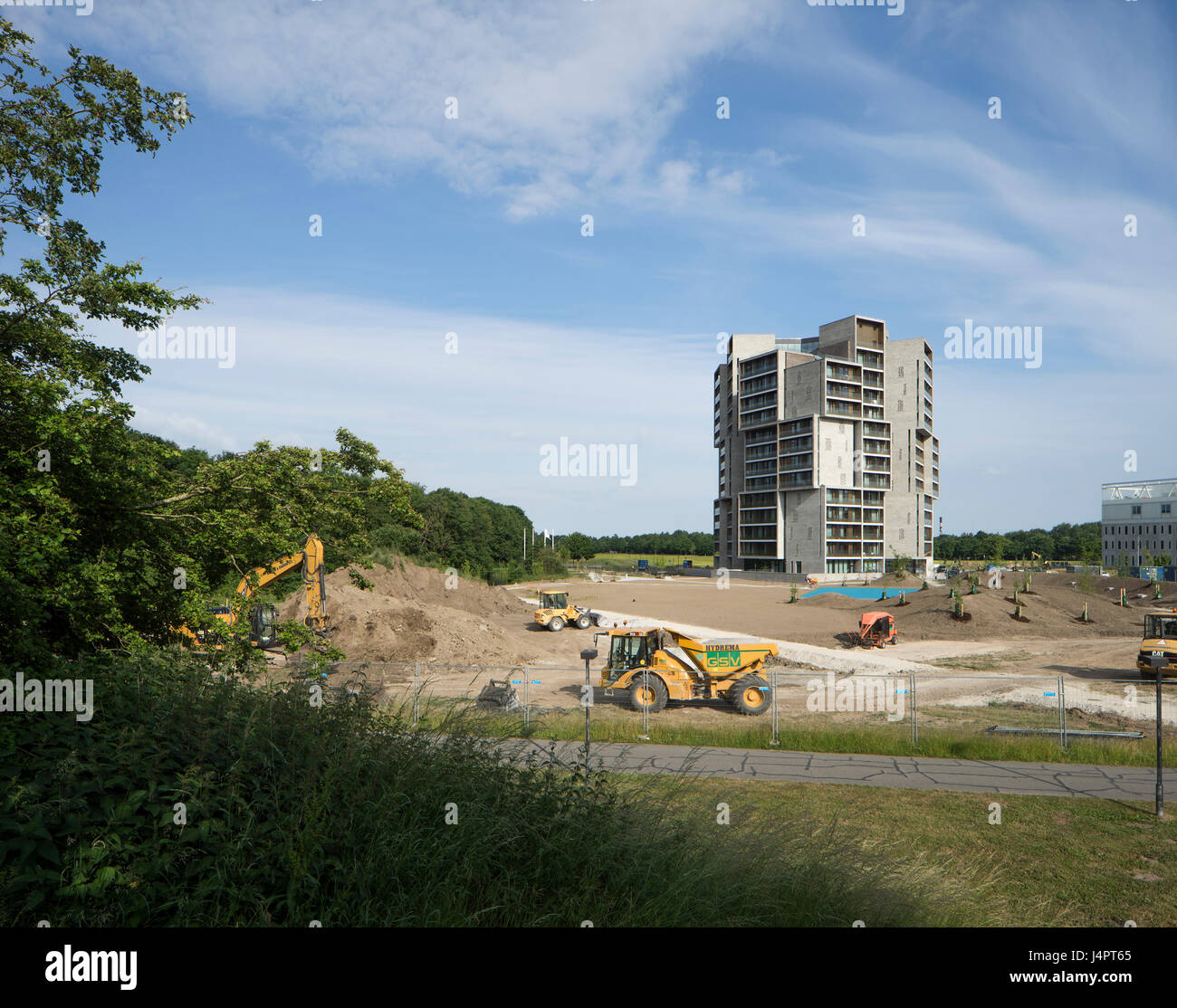 Building seen from afar with construction site. Campus Hall University ...