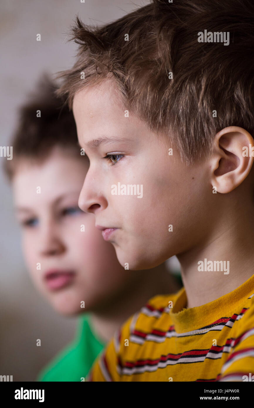 Two boys sitting together and watching aside Stock Photo - Alamy Two boys sitting together and watching aside Stock Photo - Alamy