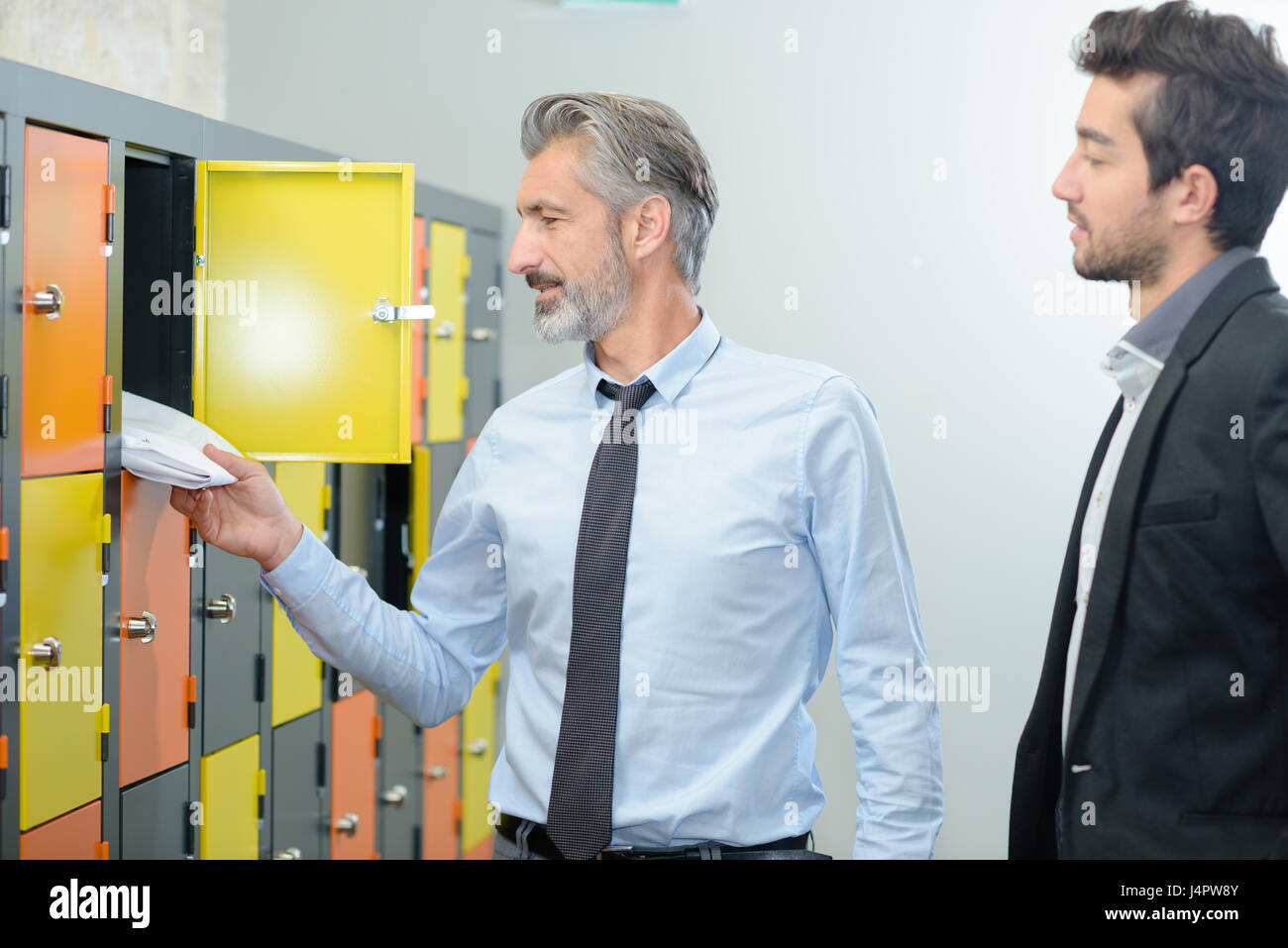 Man taking package from locker Stock Photo - Alamy