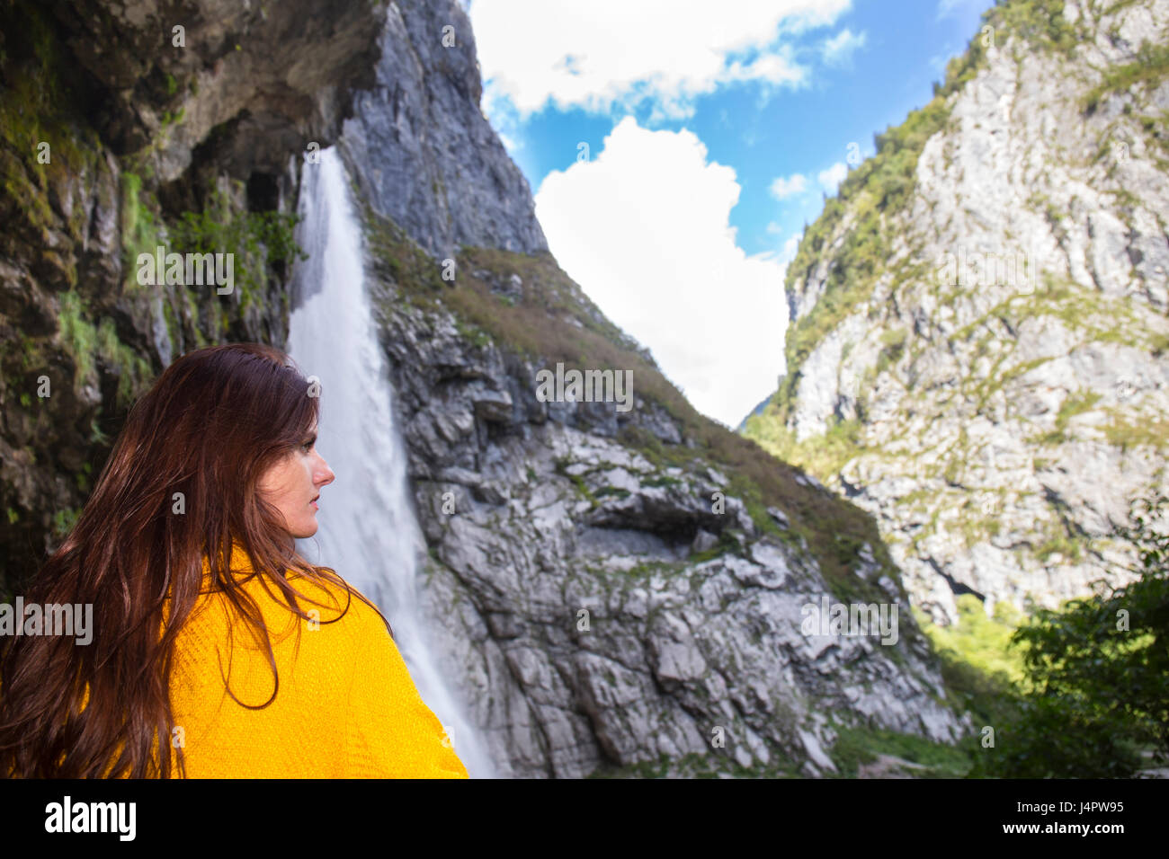 Young beautiful long hair woman's portrait on waterfall background ...