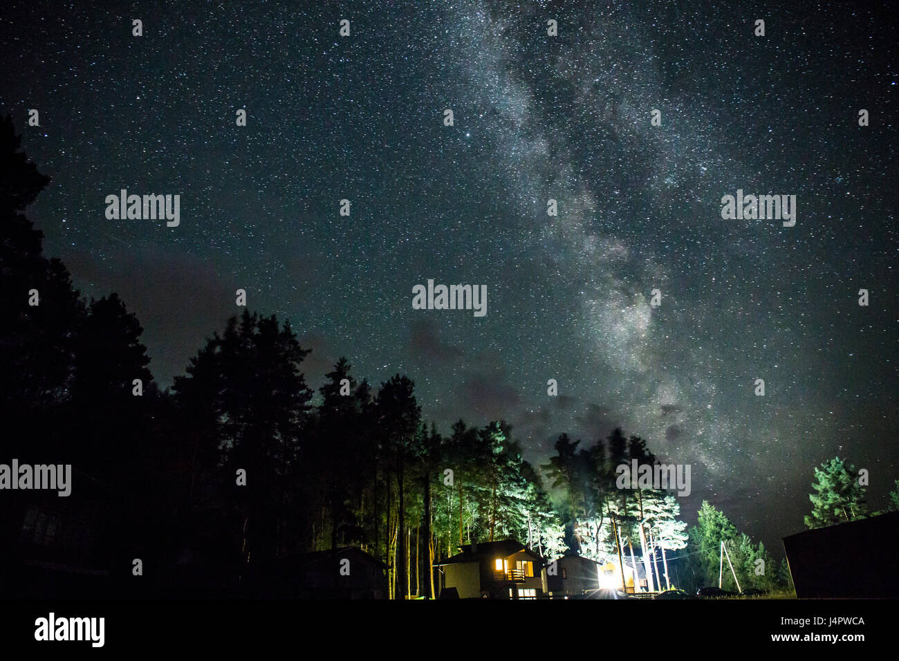 Night starry sky scene with illuminated cottage in the forest Stock ...