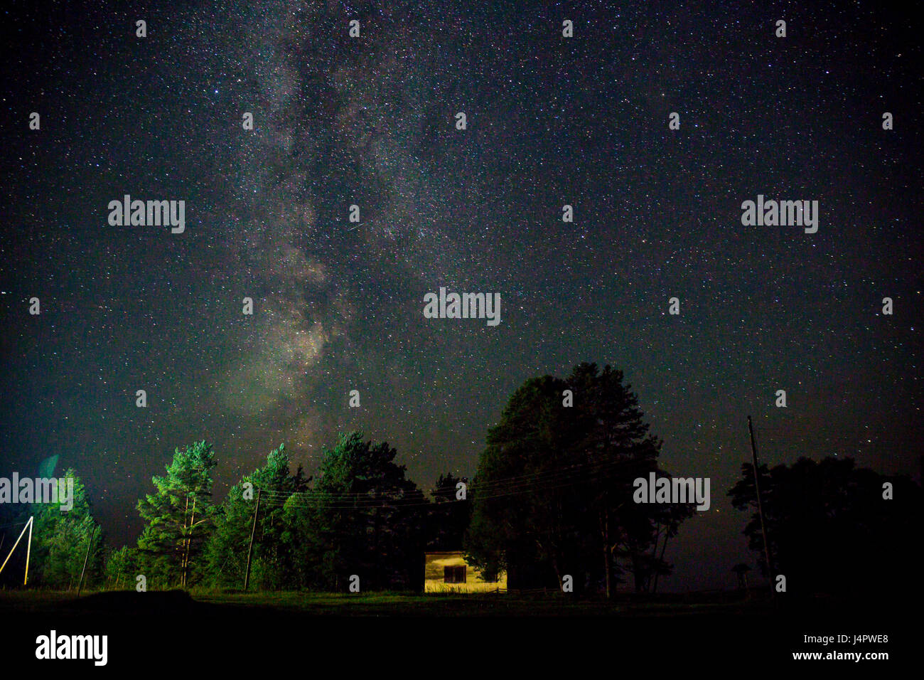 Night starry sky scene with illuminated cottage in the forest Stock ...