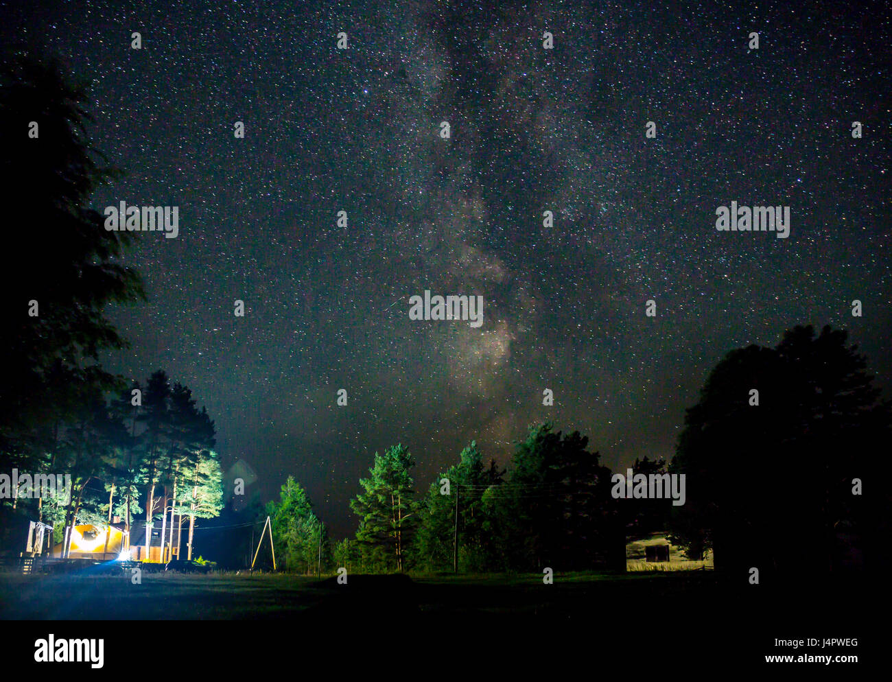 Night starry sky scene with illuminated cottage in the forest Stock ...