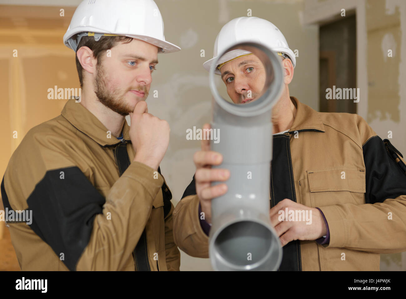 plumber holding a plastic pipe Stock Photo - Alamy
