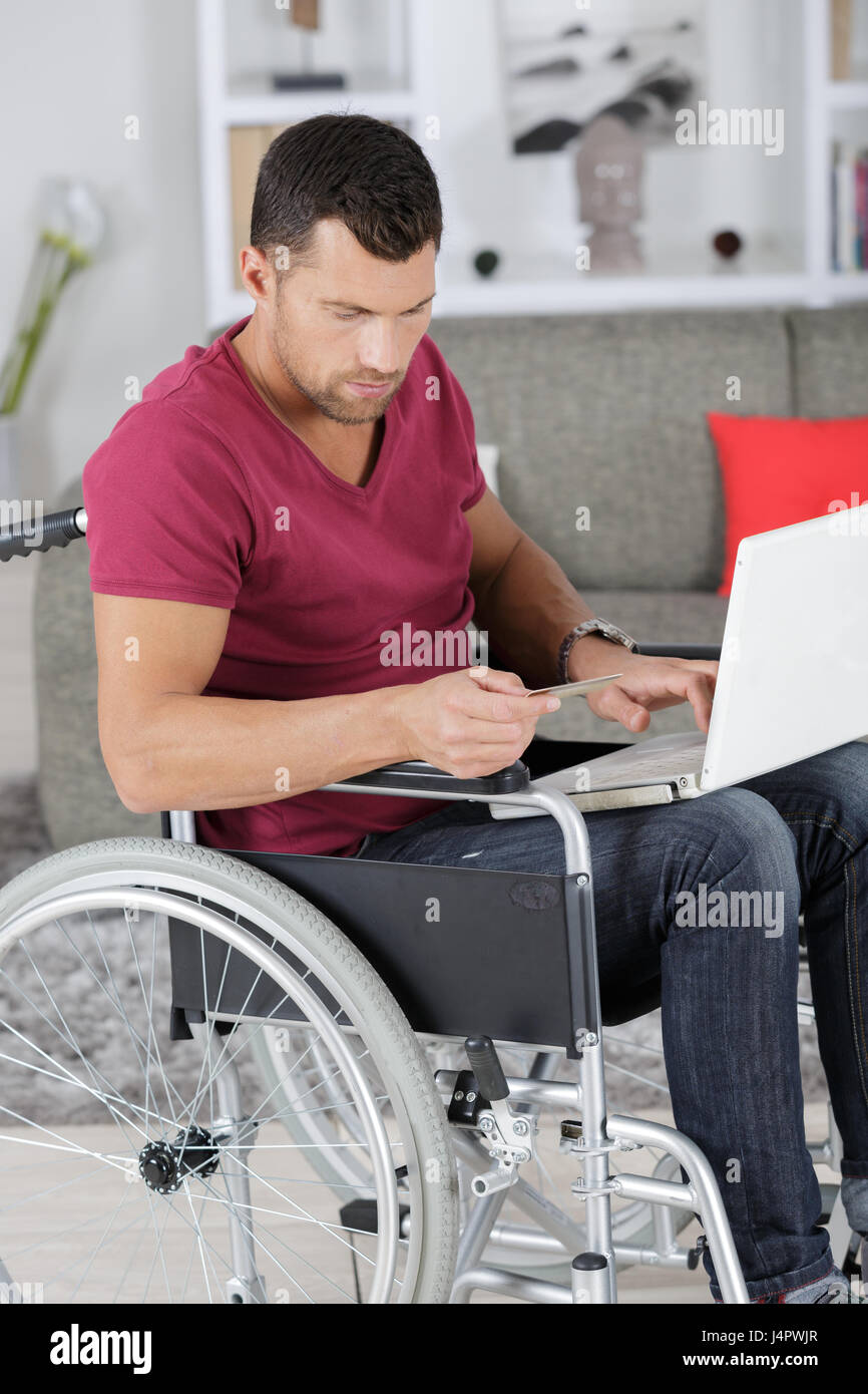 disabled man in wheelchair typing on laptop Stock Photo - Alamy
