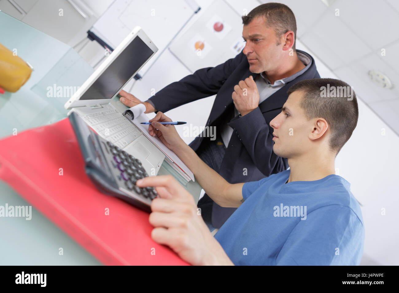 calculating using the calculator Stock Photo - Alamy