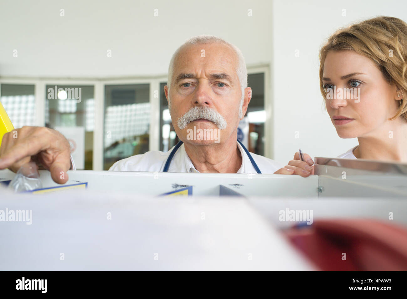 male doctor standing in front of shelves in drug store Stock Photo - Alamy