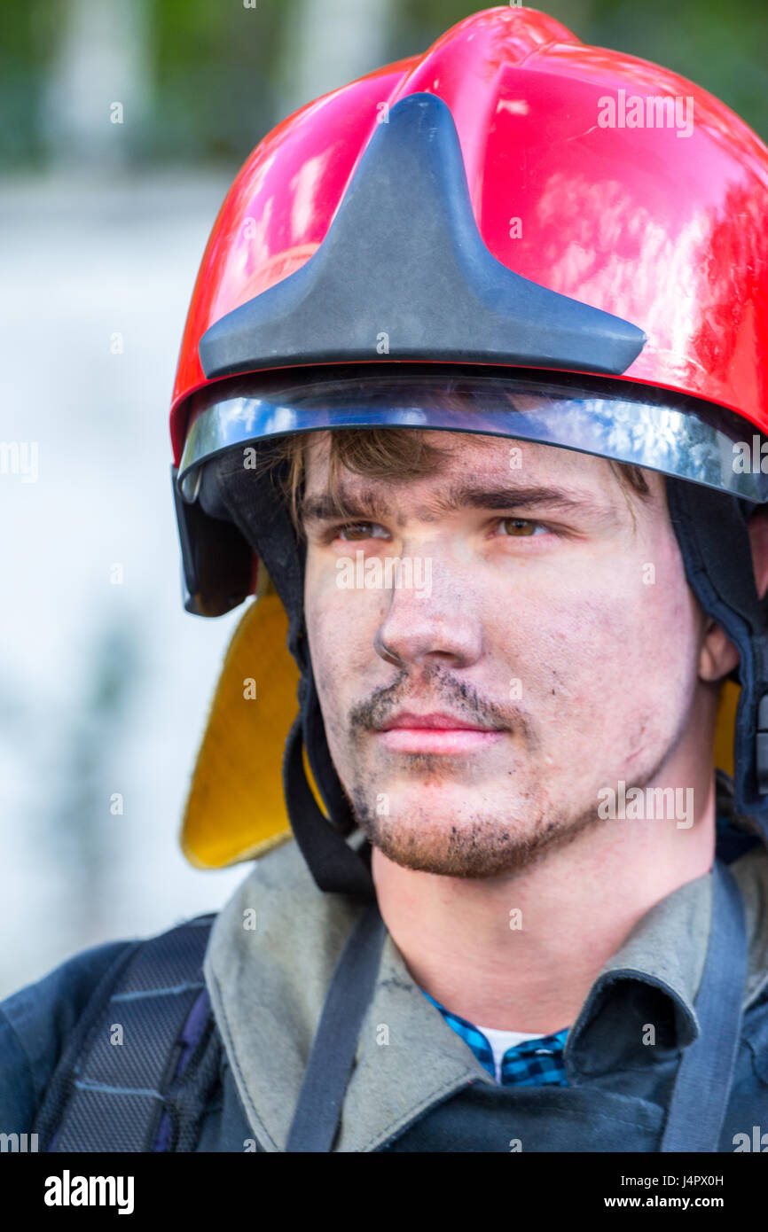 Portrait of a fireman with car on background Stock Photo - Alamy